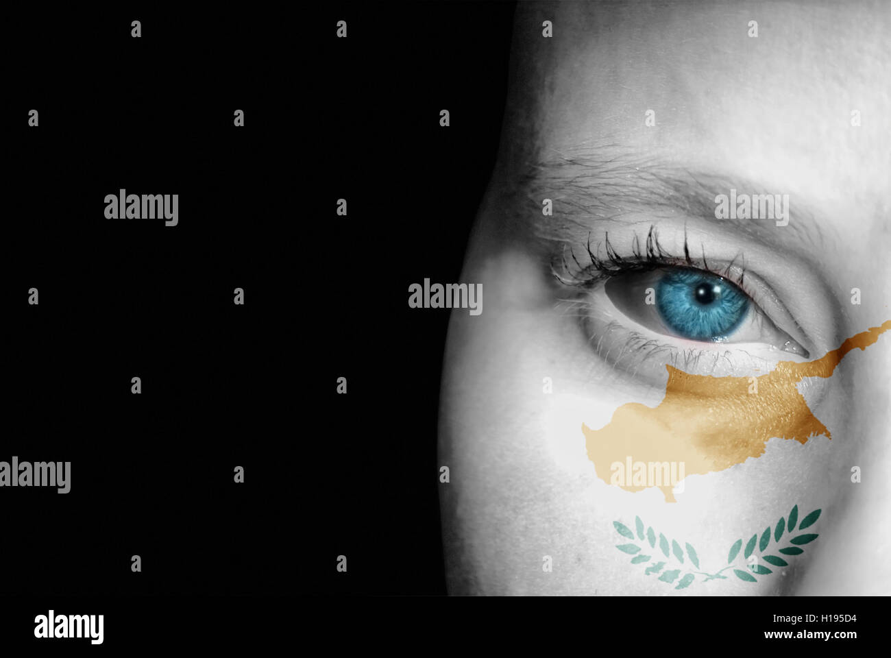 A young female with the flag of Cyprus painted on her face on her way ...