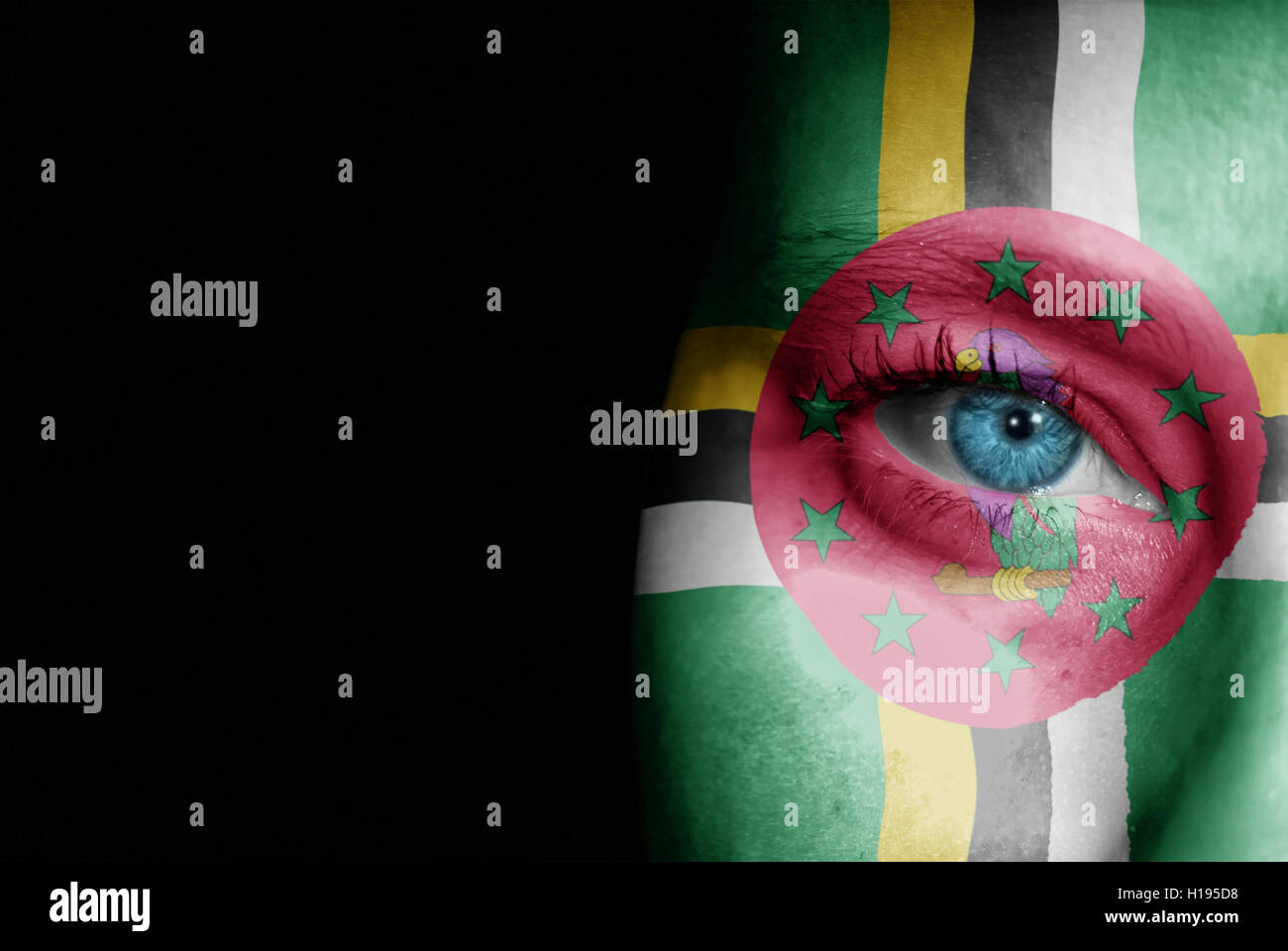 A young female with the flag of Dominica painted on her face on her way ...