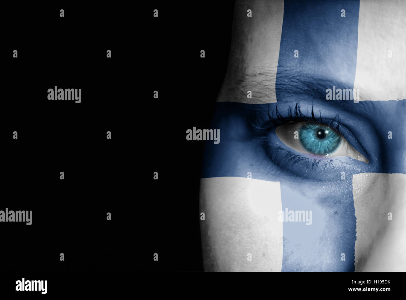A young female with the flag of Finland painted on her face on her way ...