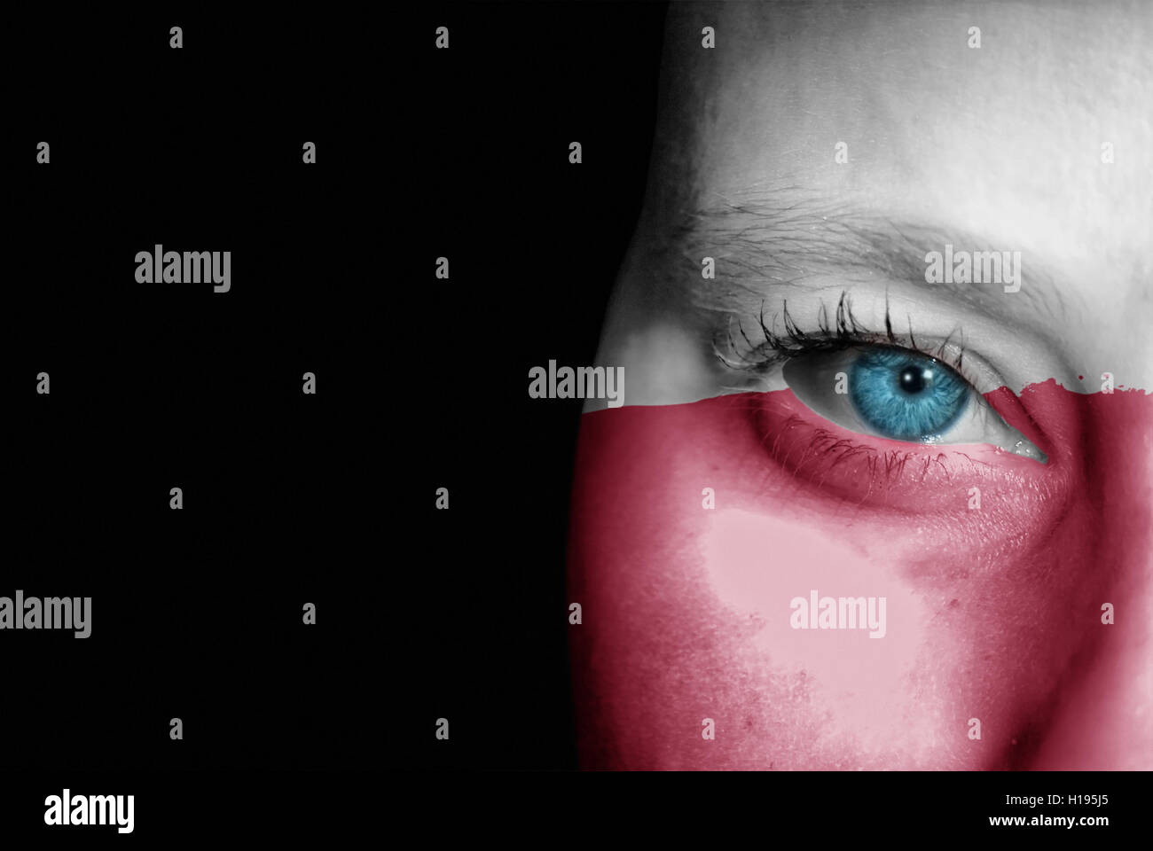 A young female with the flag of Poland painted on her face on her way ...