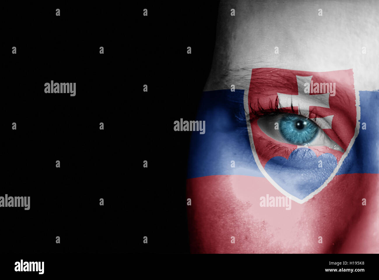 A young female with the flag of Slovakia painted on her face on her way ...