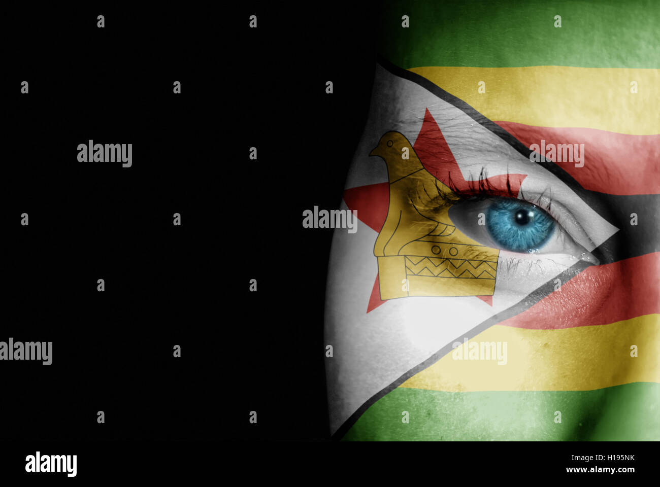 A young female with the flag of Zimbabwe painted on her face on her way ...