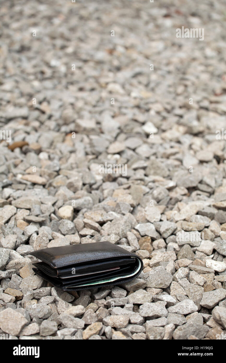 Lost black leather wallet with money lost at sidewalk Stock Photo - Alamy
