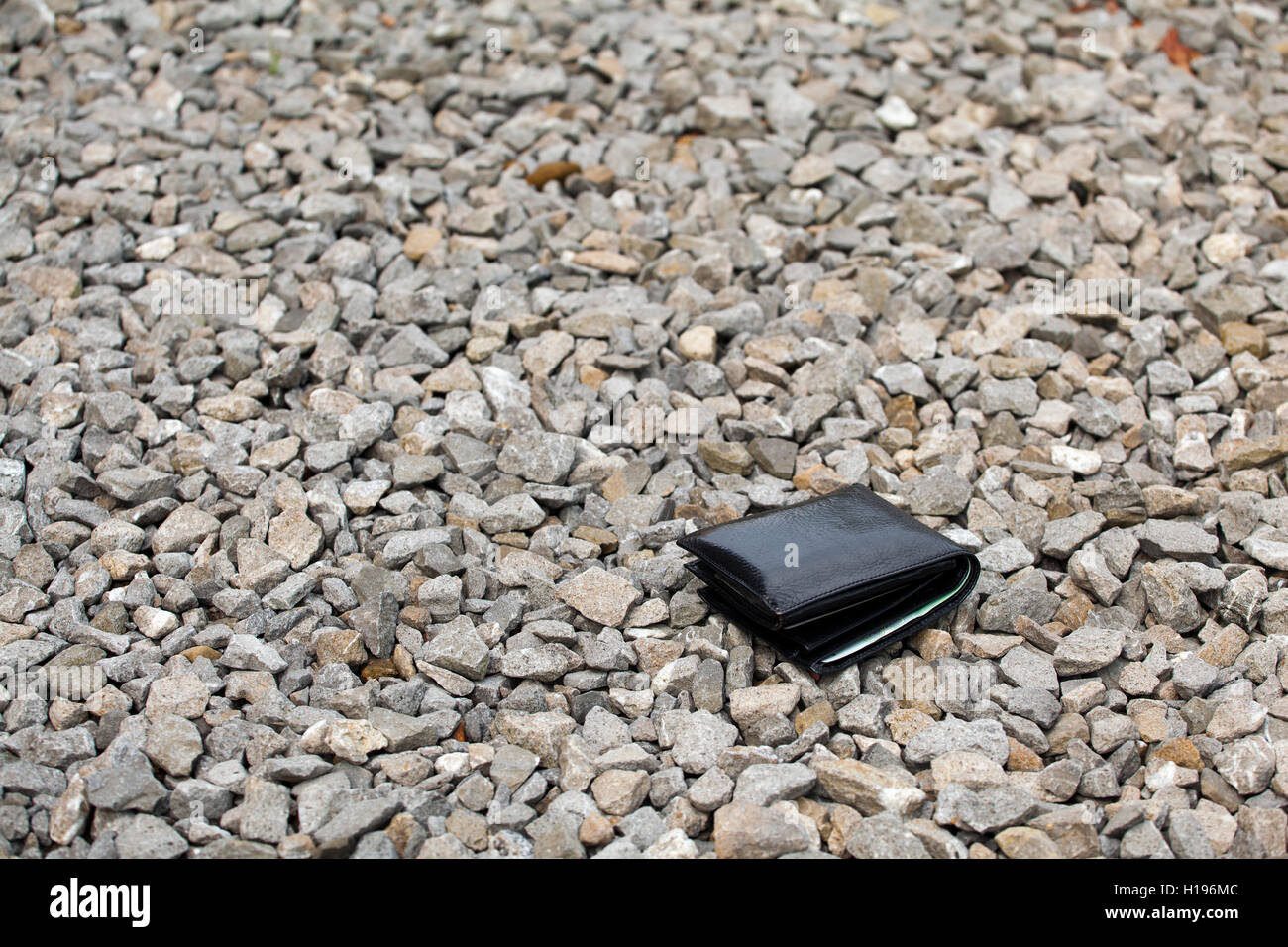 Lost black leather wallet with money lost at sidewalk Stock Photo - Alamy
