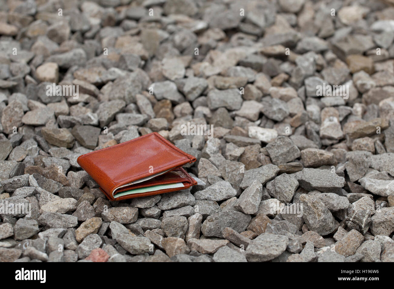 Lost leather wallet with money lost at sidewalk Stock Photo - Alamy