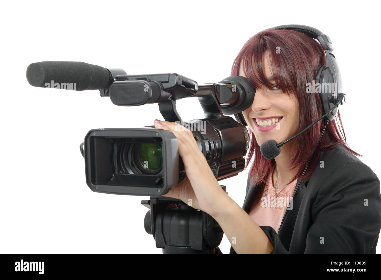 a beautiful young woman with a professional video camera and headphone ...
