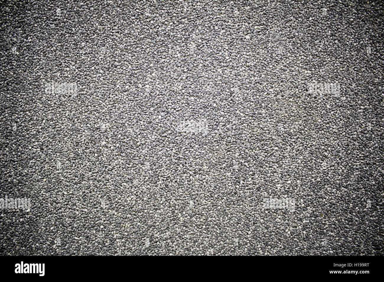 Small stones in dark urban wall construction Stock Photo - Alamy