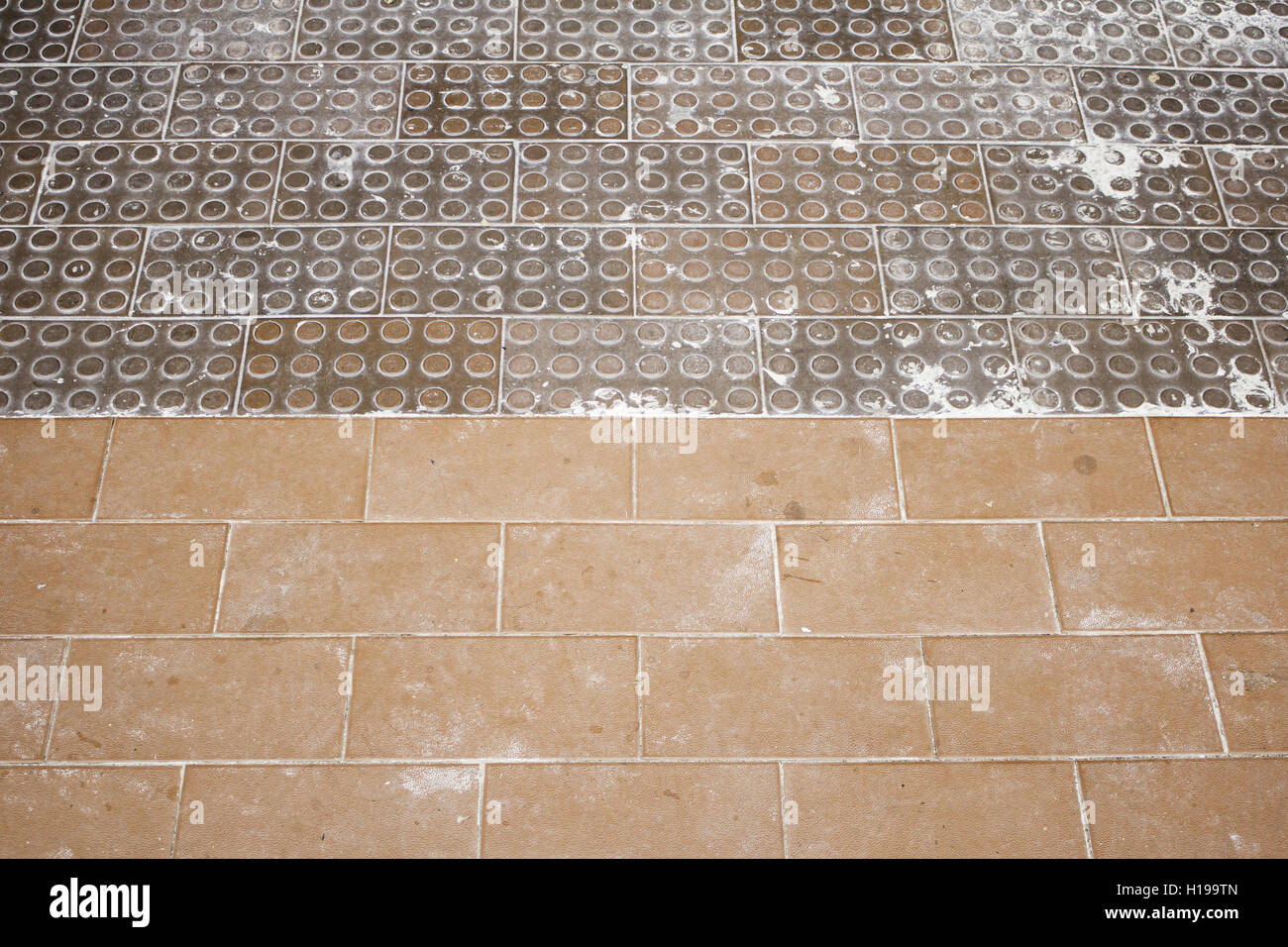 Orange and brown floor tiles in road construction Stock Photo - Alamy