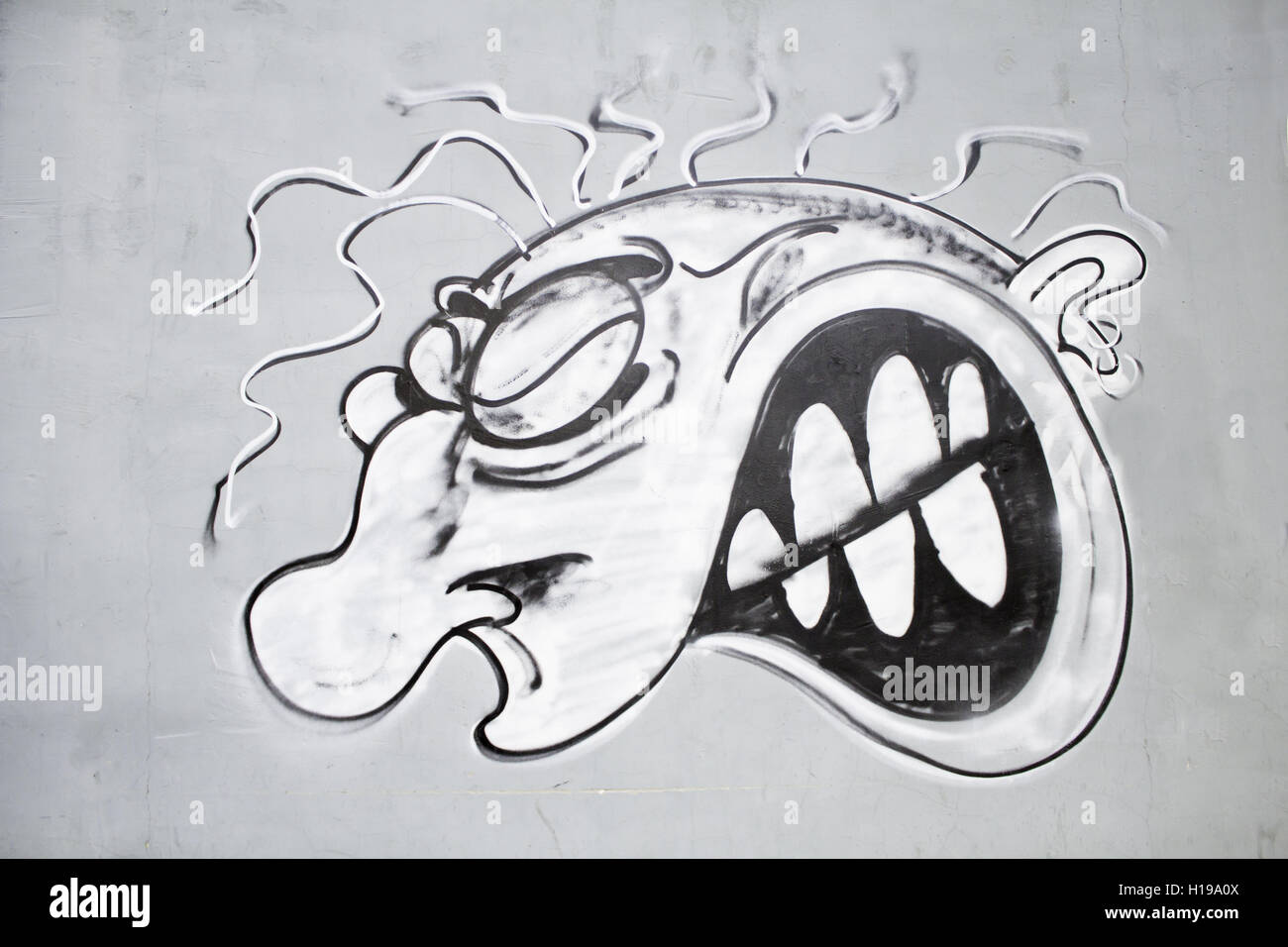 Graffiti furious face in urban wall decoration Stock Photo - Alamy