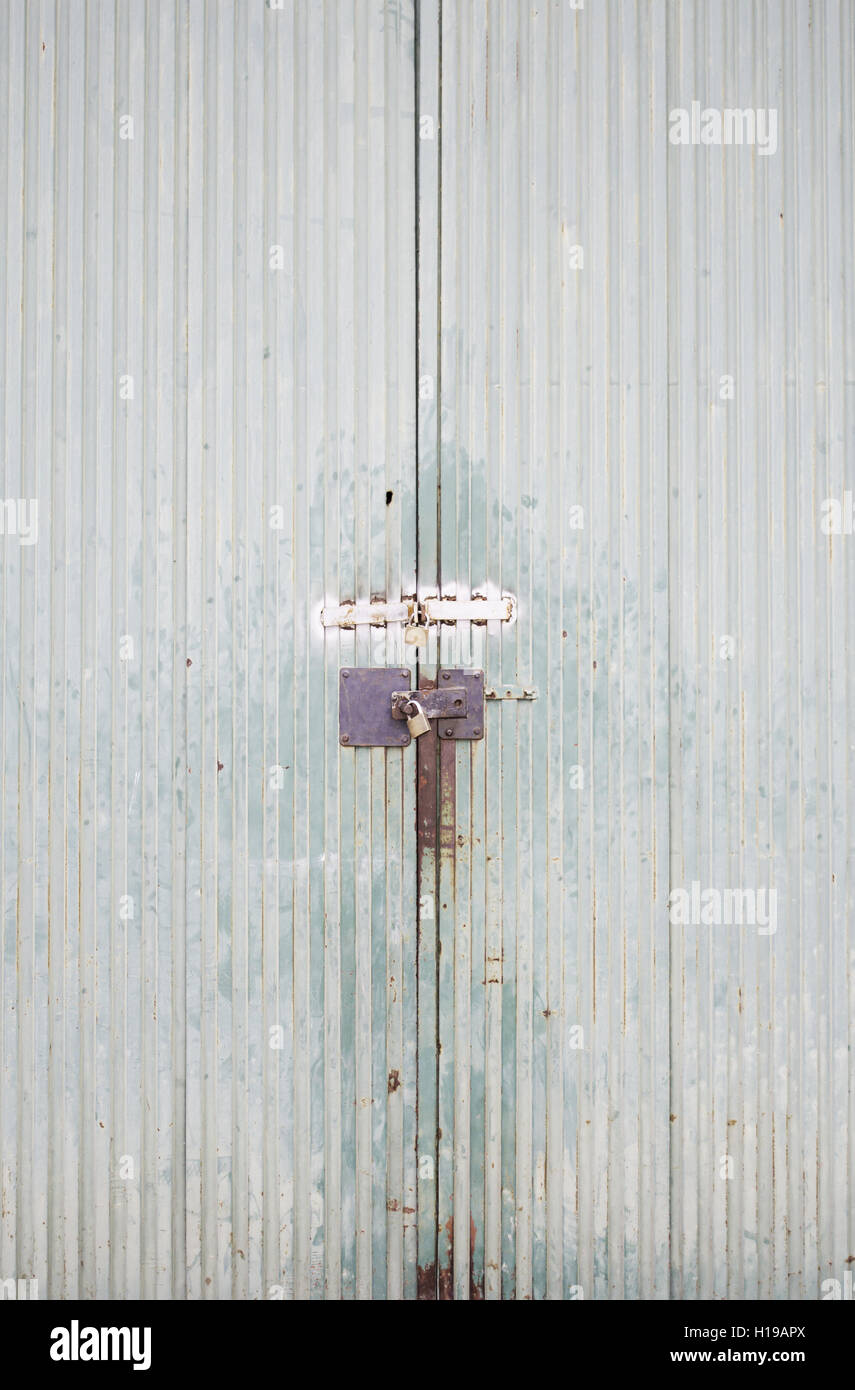 Metal door lock on industrial building protection Stock Photo - Alamy