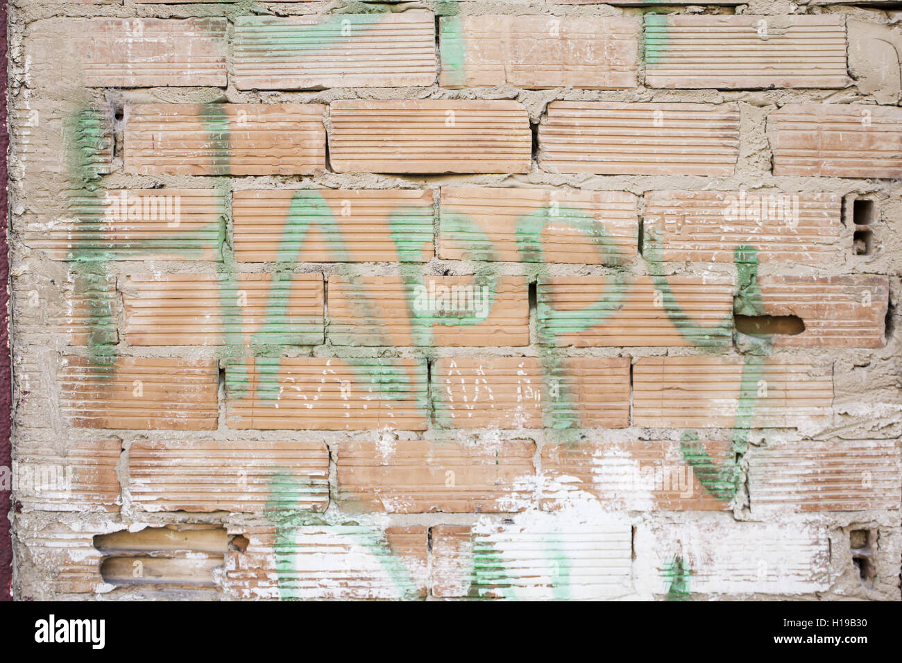 Happy symbol wall brick, construction Stock Photo - Alamy
