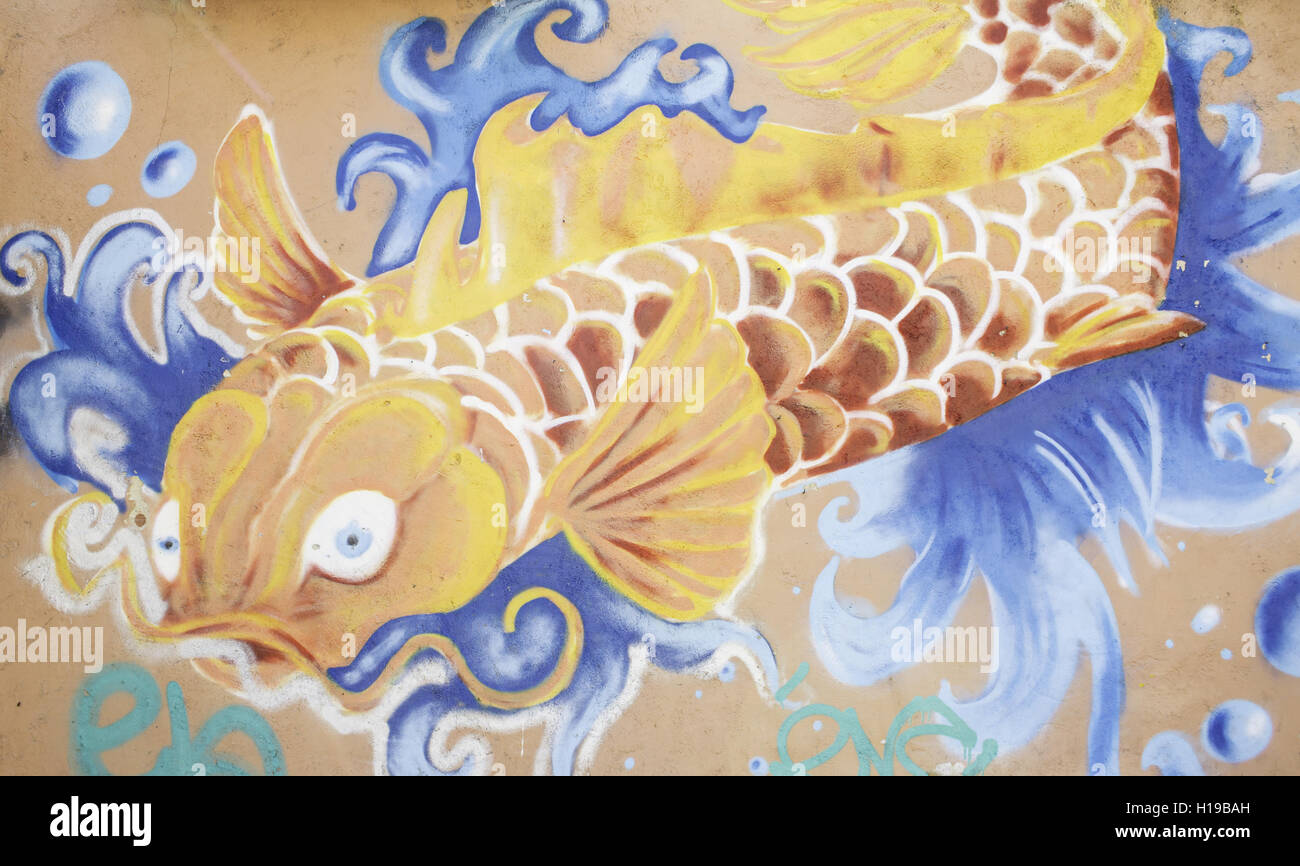 Orange fish on urban wall painted, symbol Stock Photo - Alamy