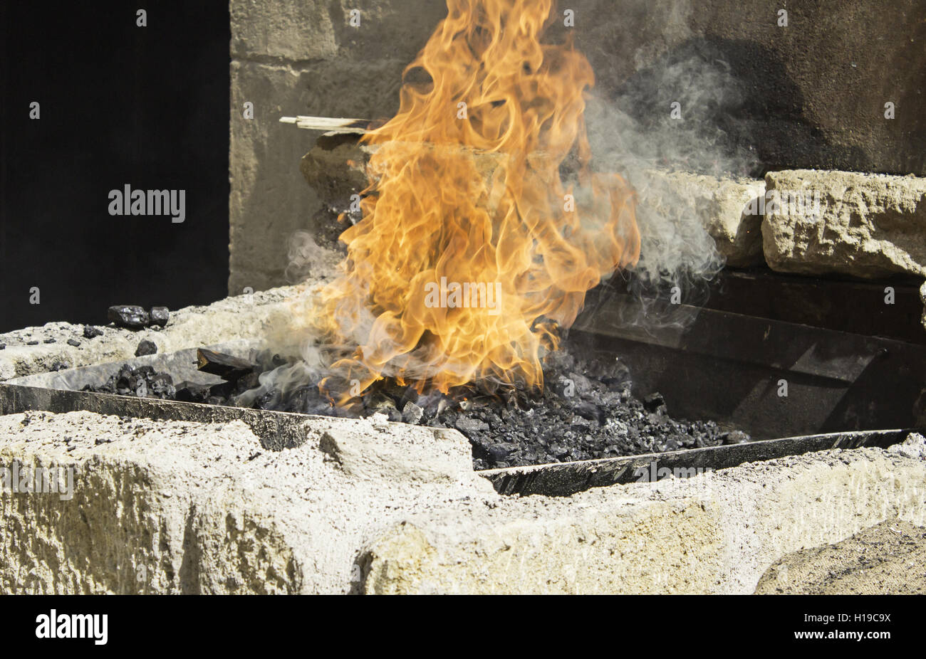 Fire on coals with ash and flame burning Stock Photo - Alamy