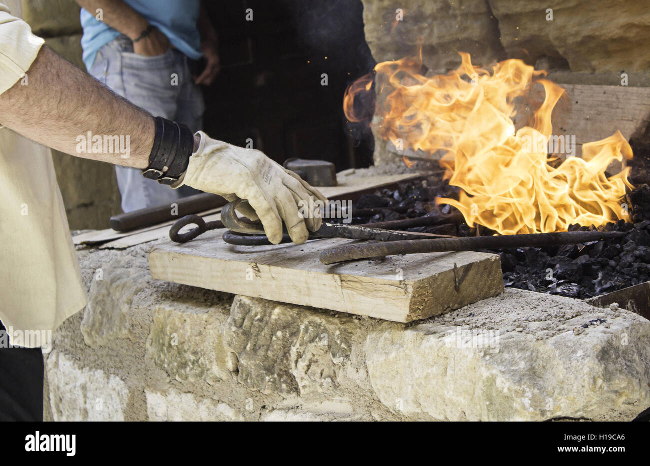 Blacksmith working with fire and embers, artisan Stock Photo - Alamy