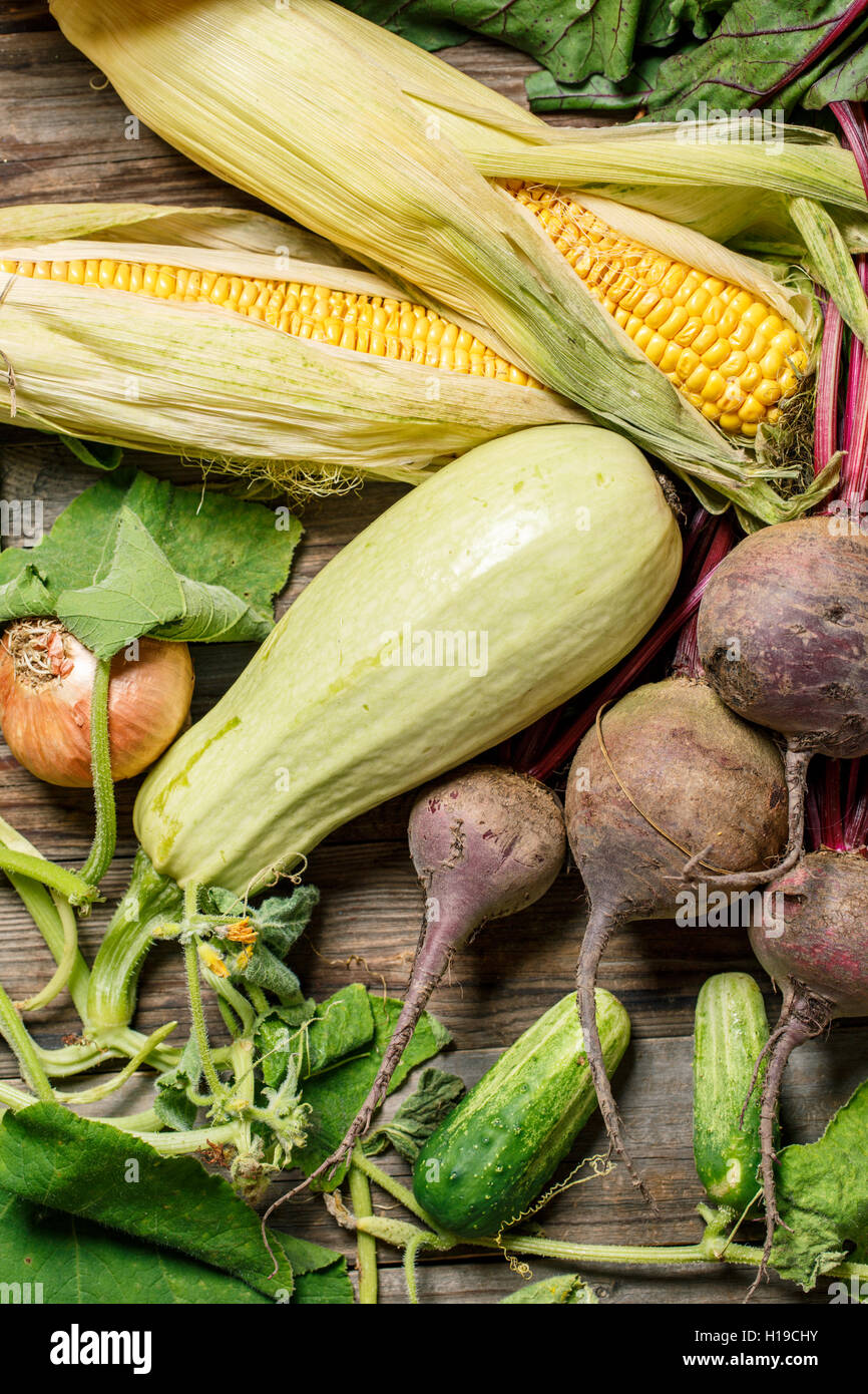 Sweetcorn, vegetable marrow, cucumber and beets on wooden background ...