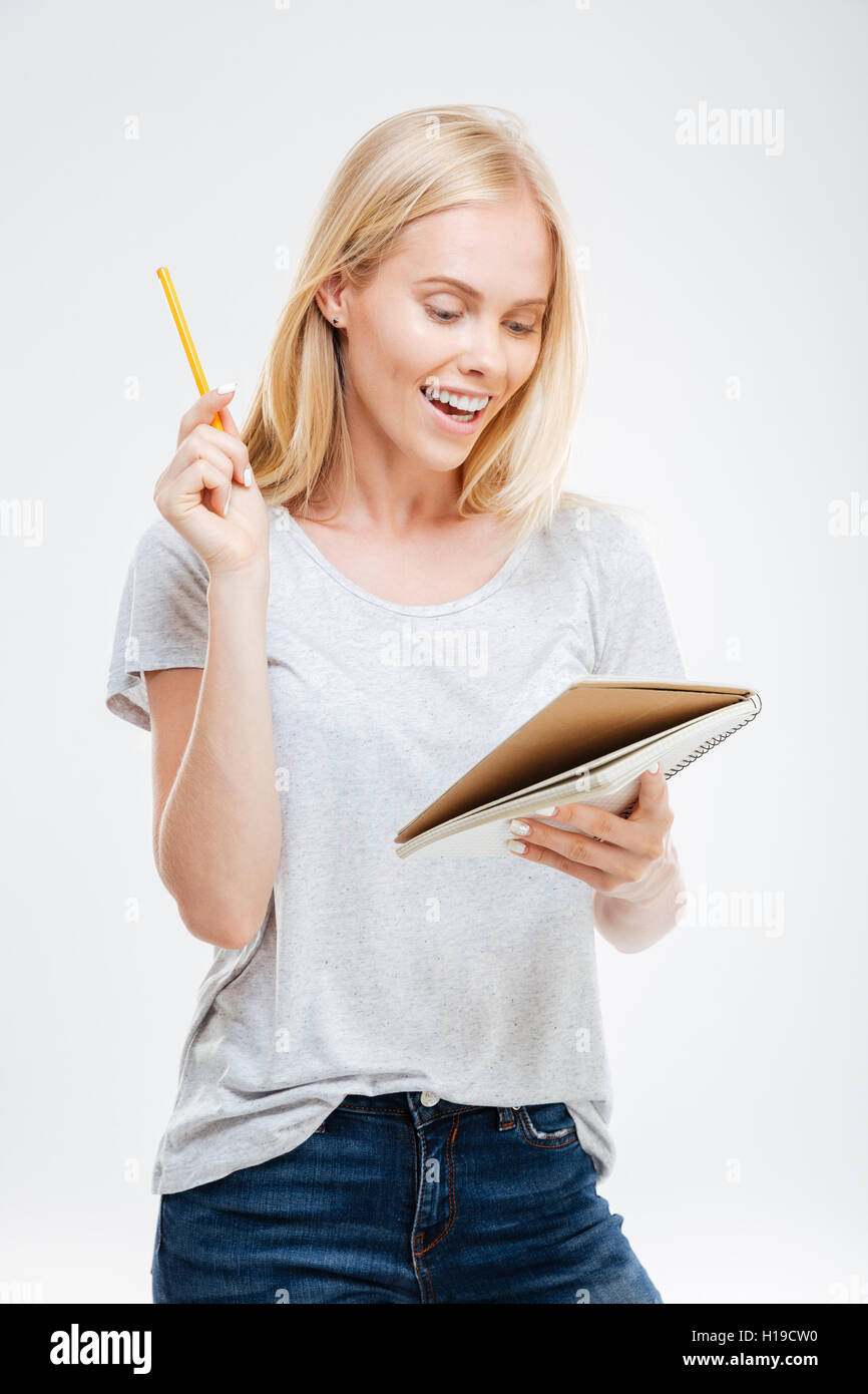 Laughing cheerful pretty girl holding notebook with idea isolated on ...