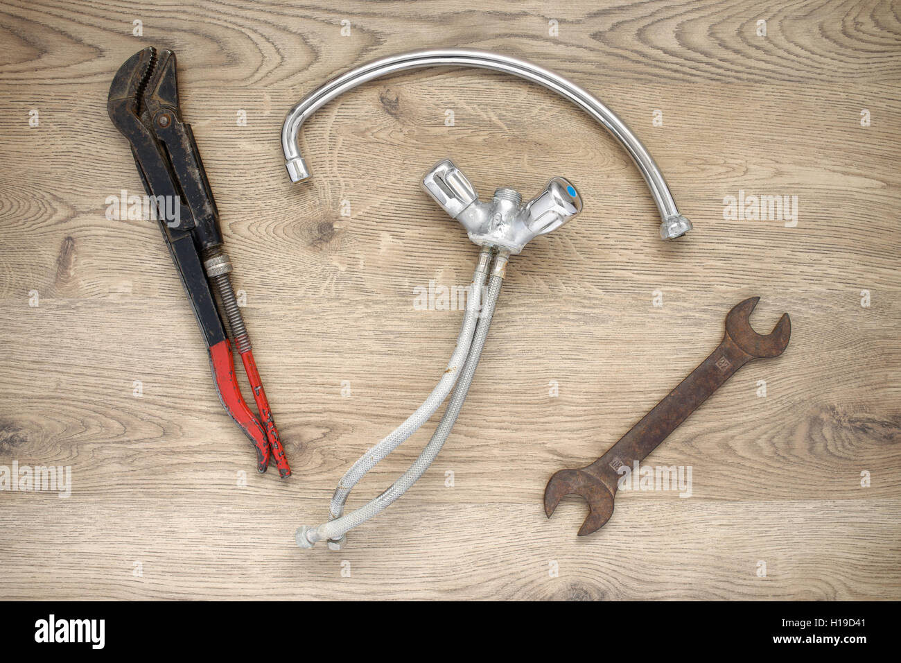 Rusty old plumbing tools and tap on wooden background Stock Photo - Alamy