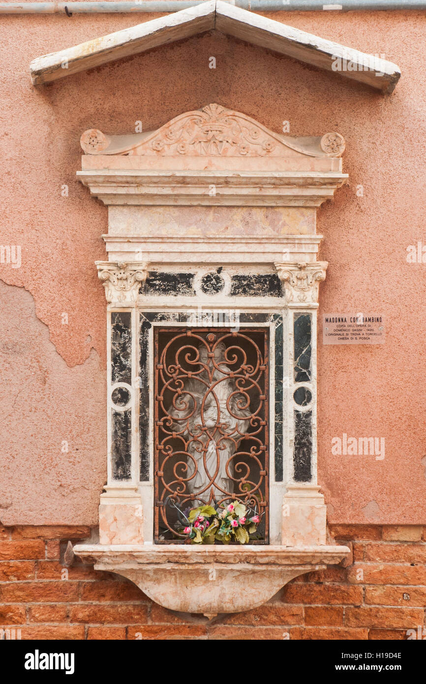 A catholic votive shrine on the wall of the St. Giacomo da l'Orio ...