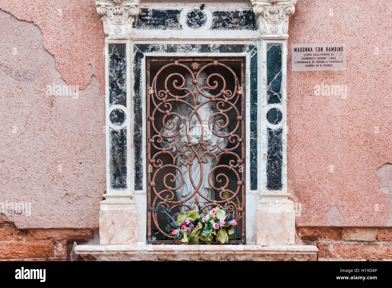A catholic votive shrine on the wall of the St. Giacomo da l'Orio ...