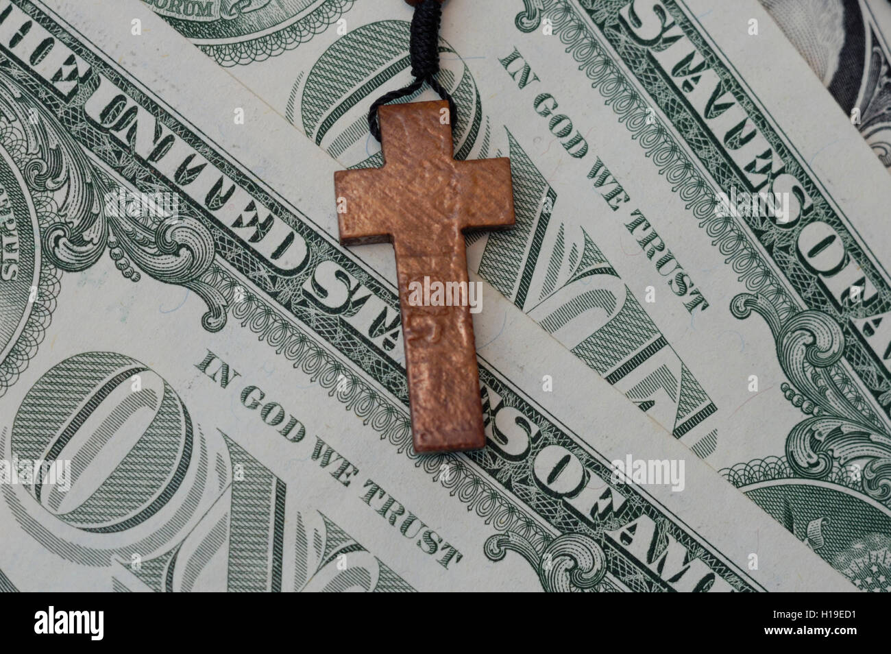 Wooden Cross on Dollars Stock Photo - Alamy