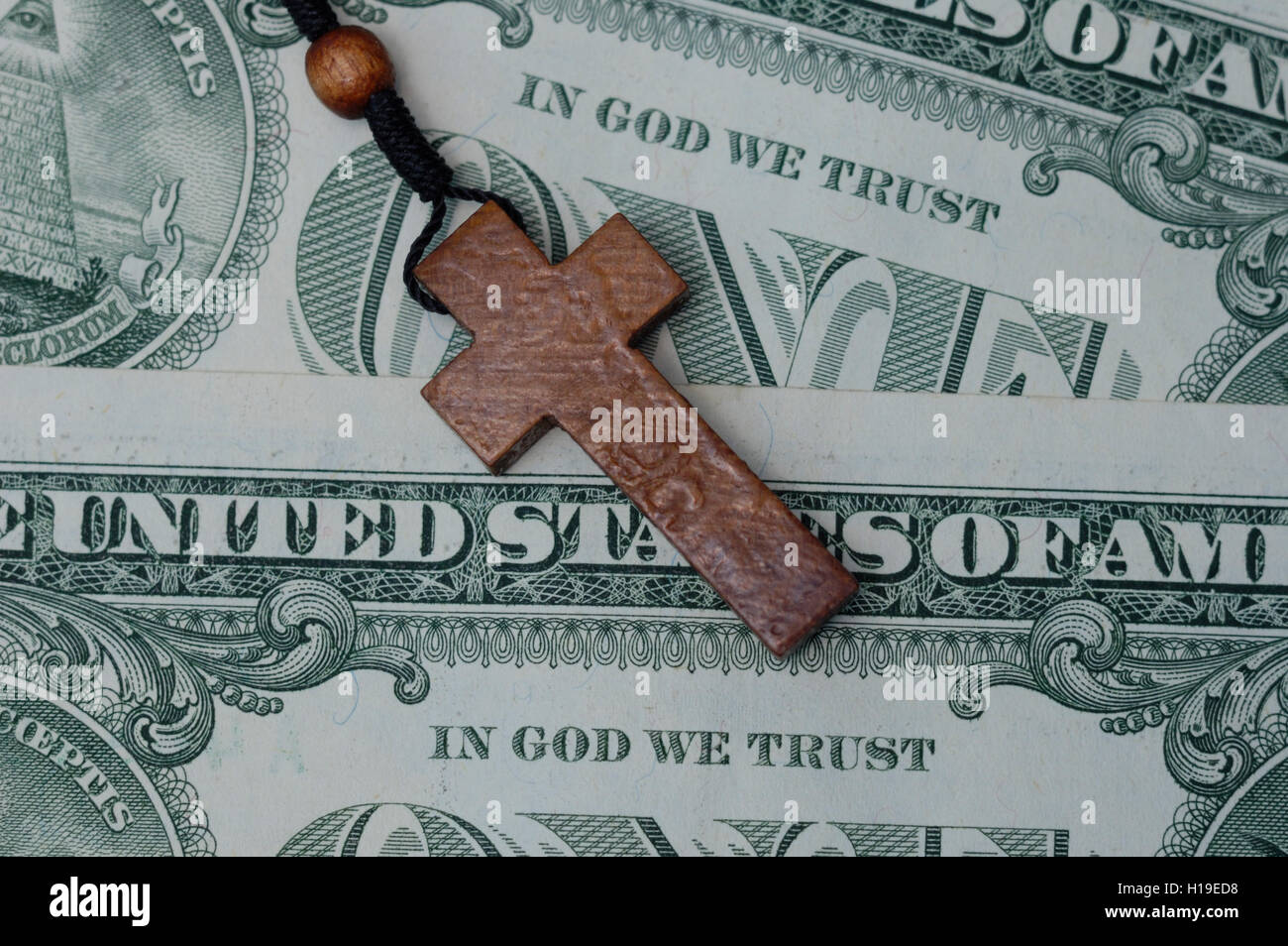 Wooden Cross on Dollars Stock Photo - Alamy