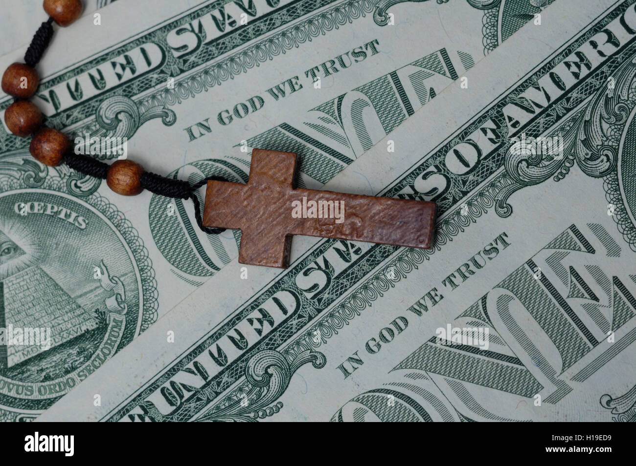 Wooden Cross on Dollars Stock Photo - Alamy