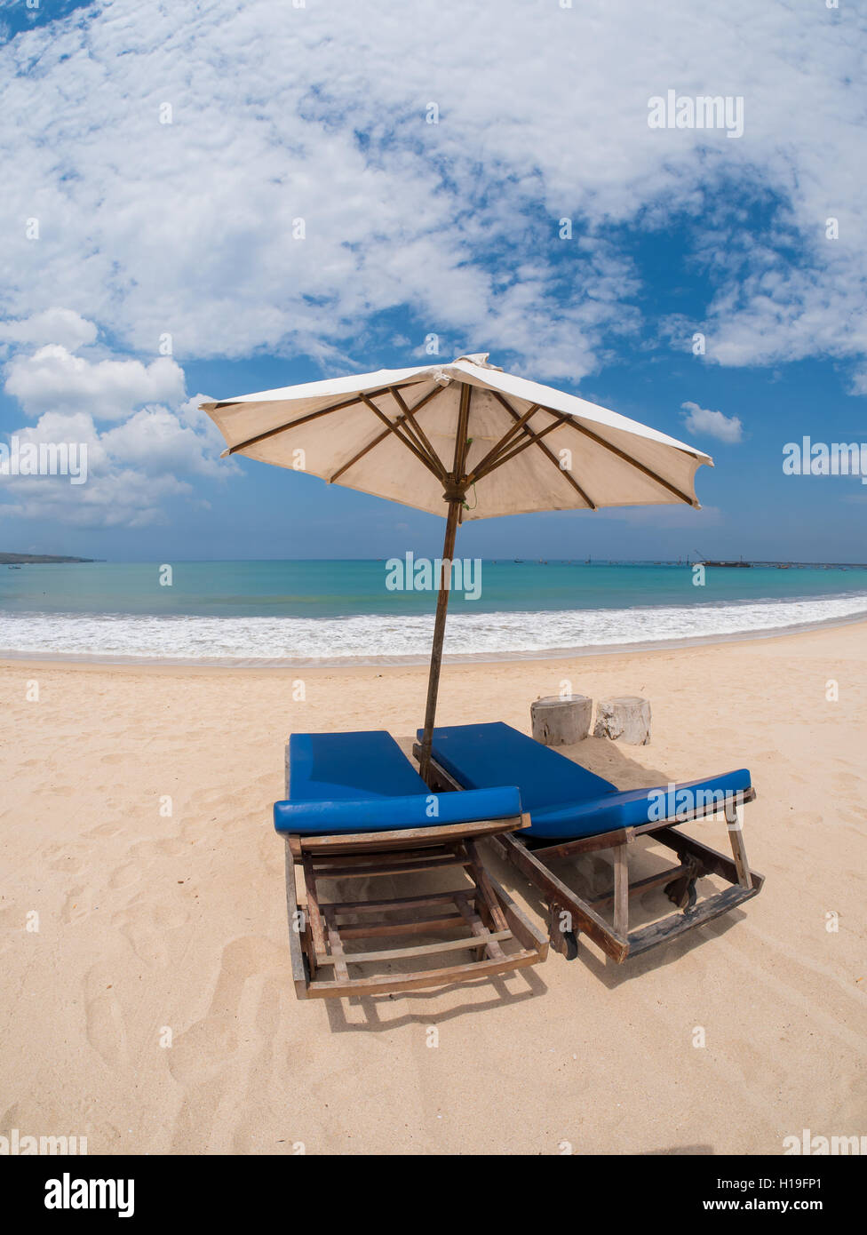 Relaxing couch chairs with parasol on white sandy Beach looking towards ...