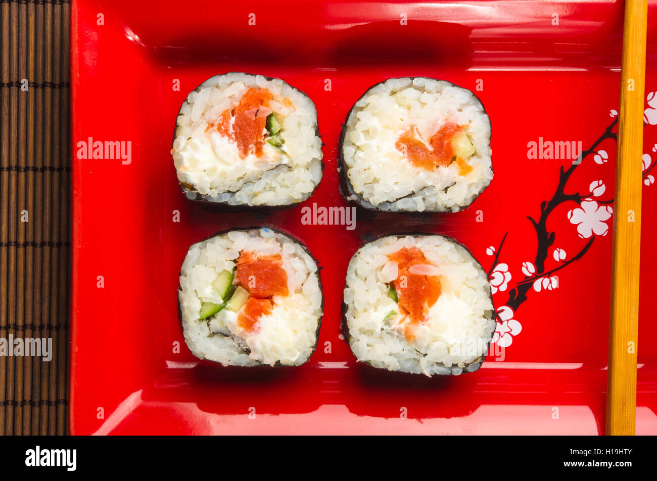 still life - set the rolls on a red plate on bamboo mat Stock Photo - Alamy
