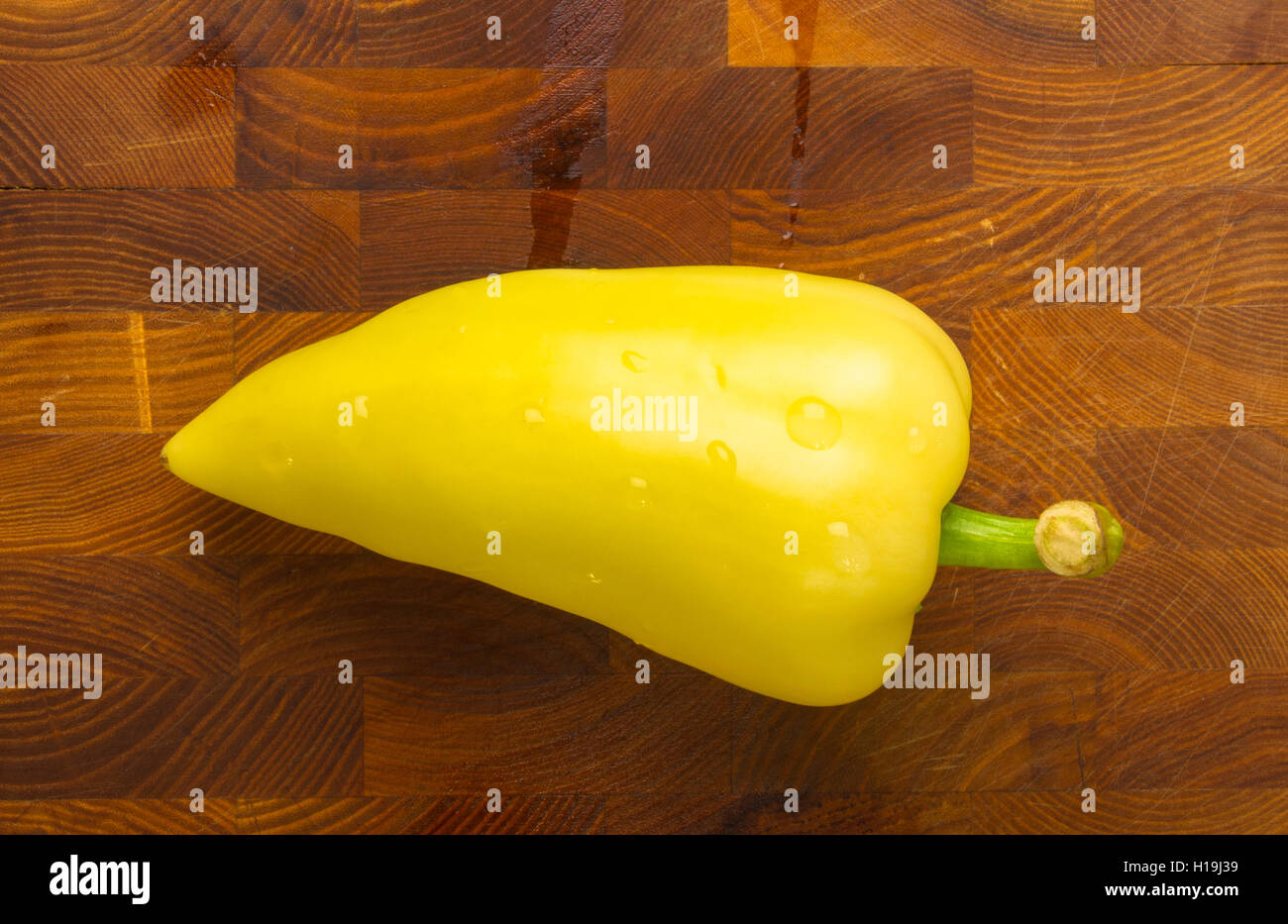 still life - yellow pepper on wooden Board Stock Photo - Alamy