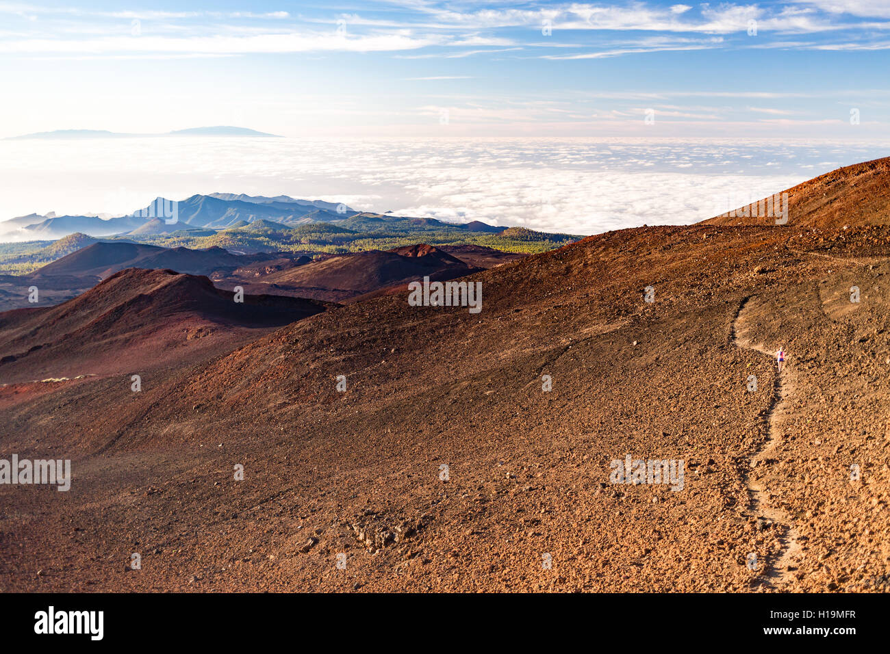 Inspirational landscape view with woman running in mountains on rocky ...