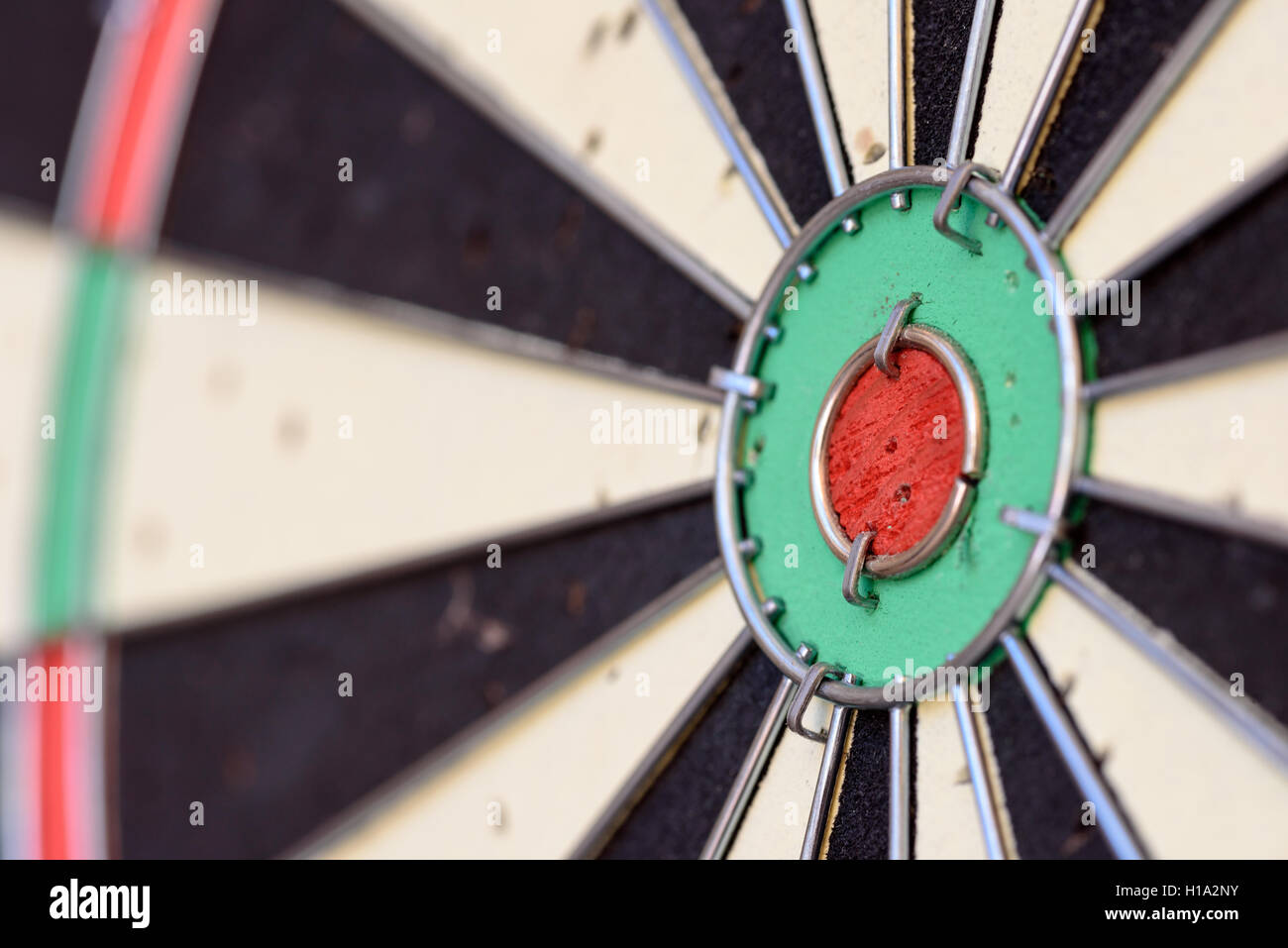 Closeup of a bullseye on a used dart board. The bulls eye is red Stock ...