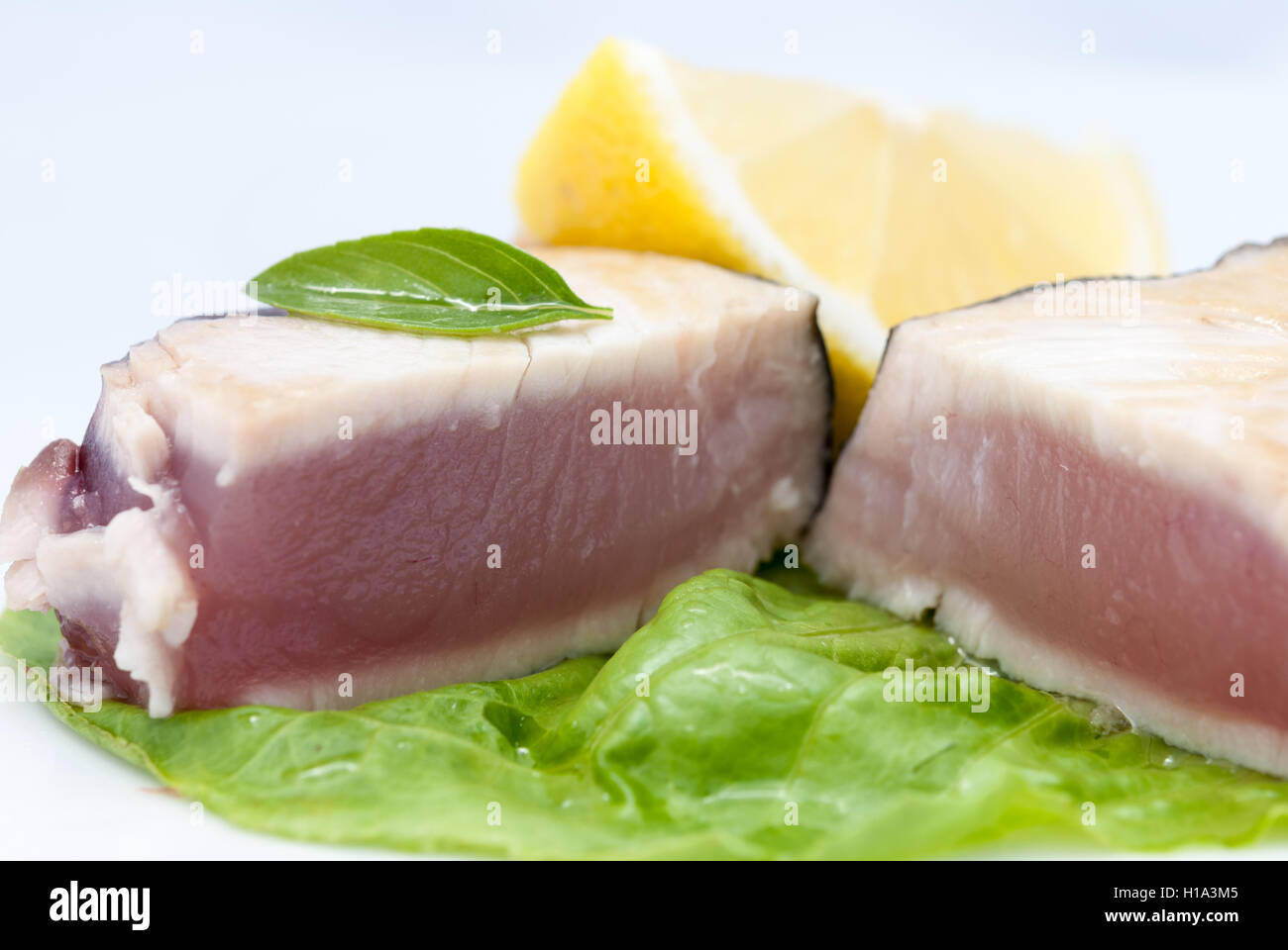 Lightly fried fillet of red tuna with a piece of lemon closeup Stock ...