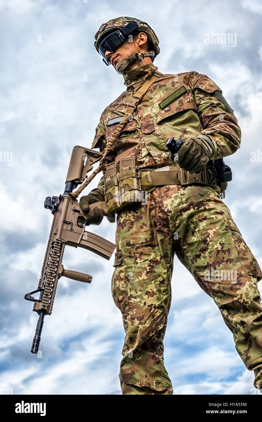 Young handsome man holding hand gun hi-res stock photography and images ...
