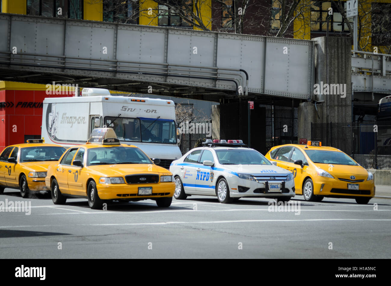 NYPD Police Car and Yellow Cabs in a line in New York City Stock Photo ...