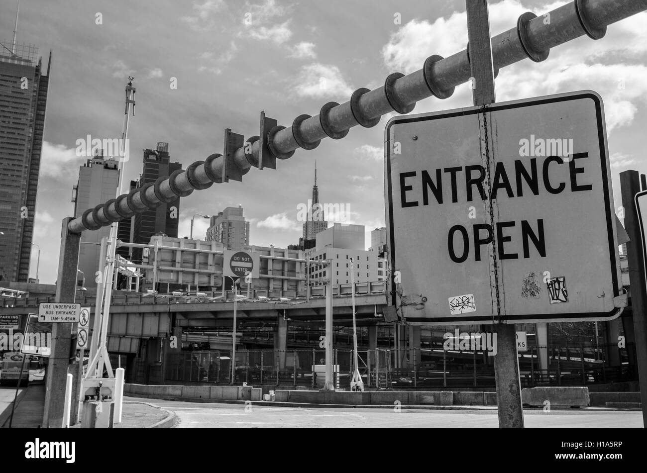 Entrance Open Sign in New York, with the Manhattan skyline in the ...