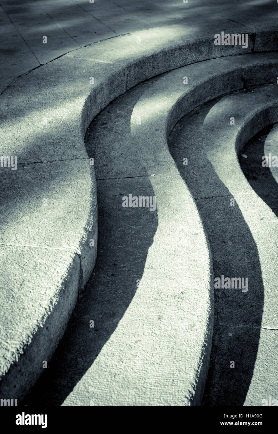 Concrete stone steps in a wavy flowing form in black and white creating ...