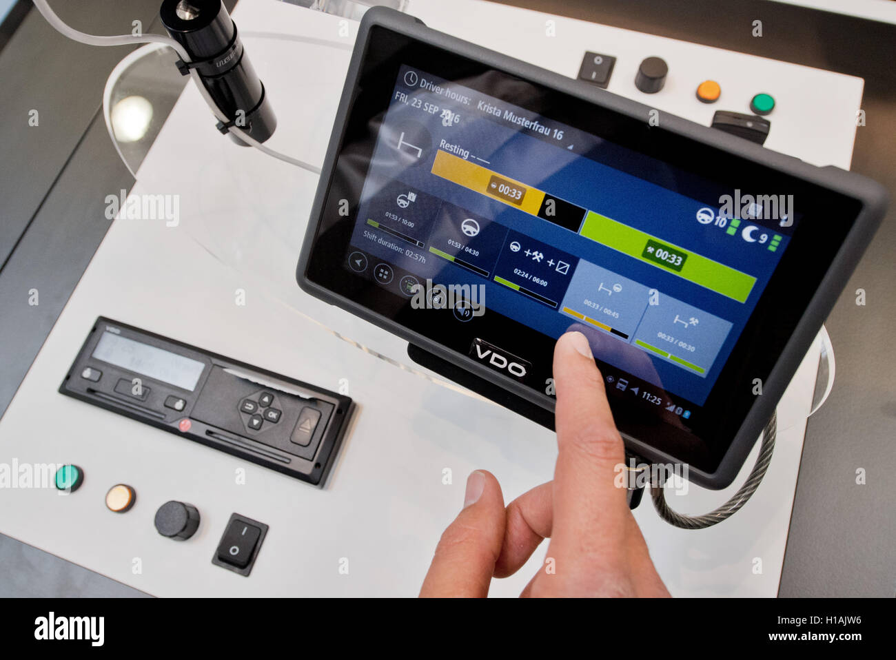 A digital tachograph (bottom L) and an additional monitor of the ...