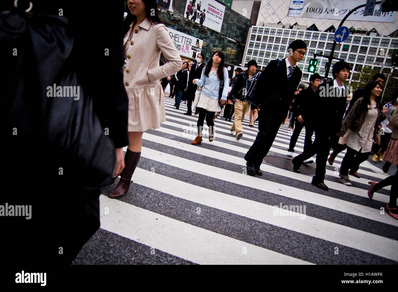 People cross a zebra crossing in the Shinjuku area of Tokyo, Japan ...