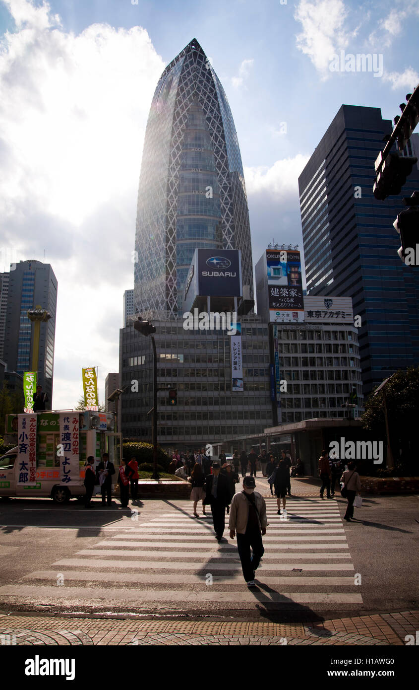 People cross a zebra crossing in the Shinjuku area of Tokyo, Japan ...