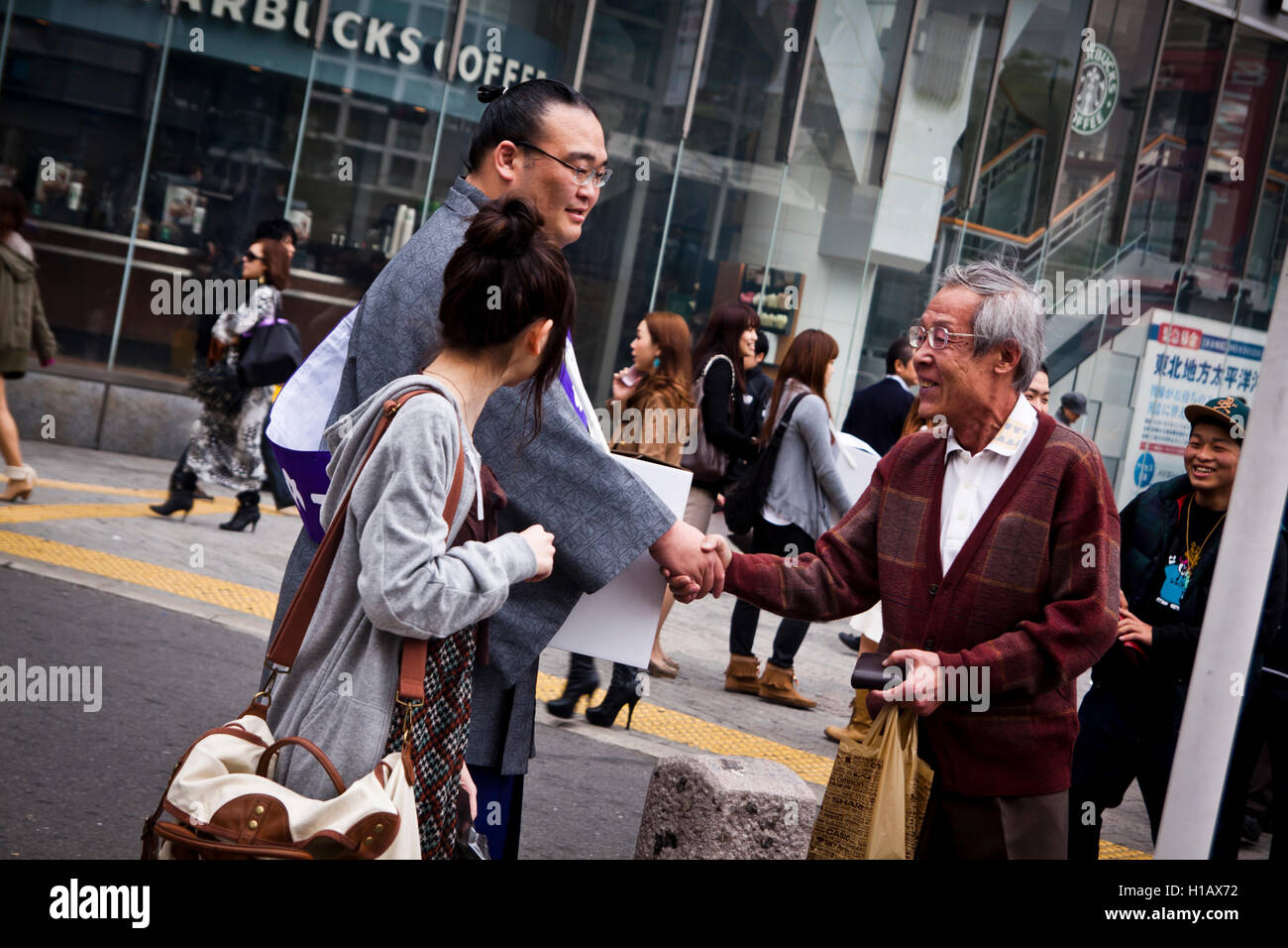 A famous sumo wrestler being interviewed in the street in Tokyo, Japan ...