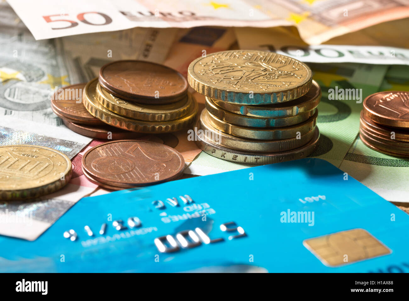 euros bank note and small change on the desk Stock Photo - Alamy