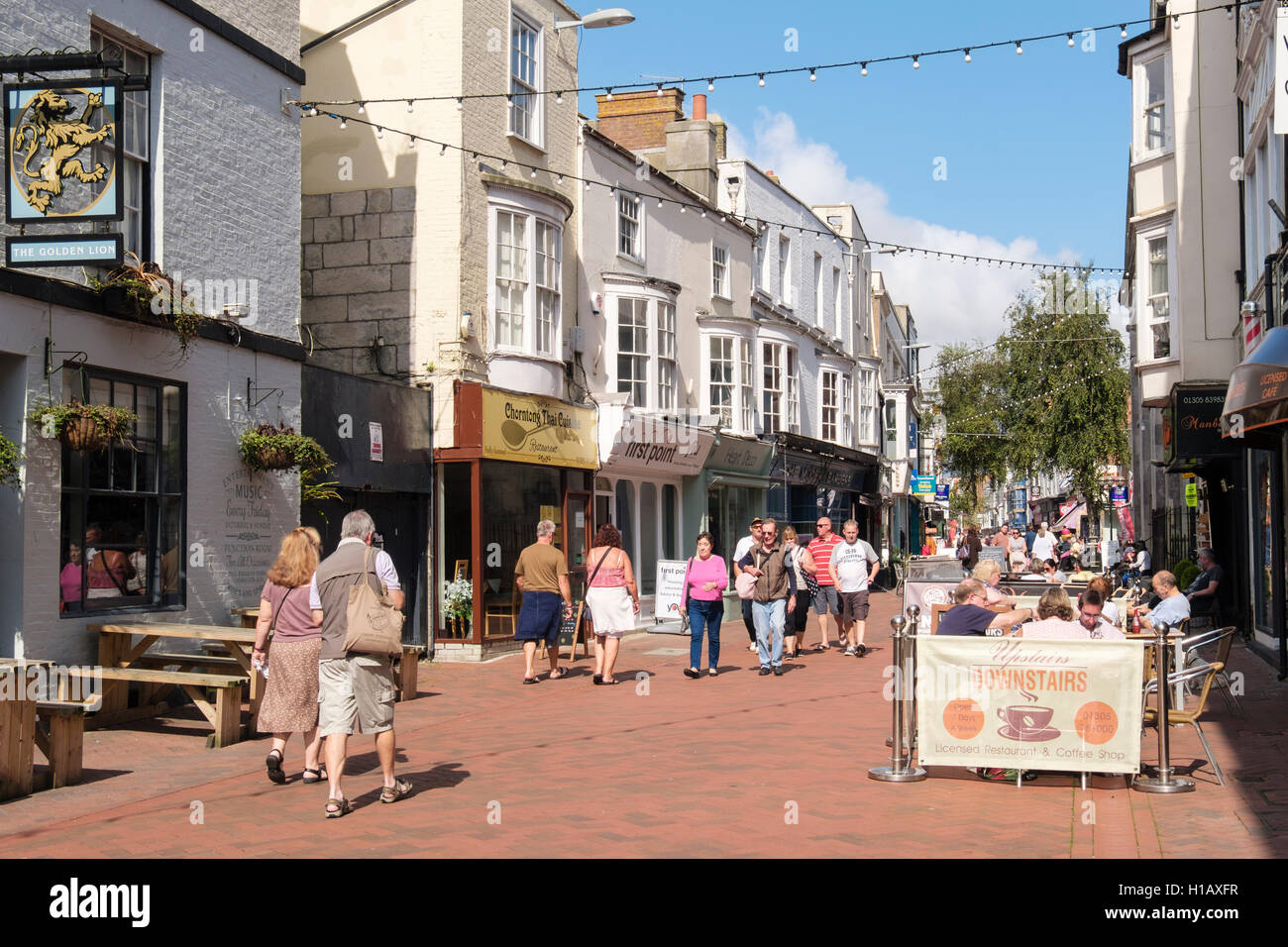Busy street scene on pedestrian shopping precinct in town centre. St ...