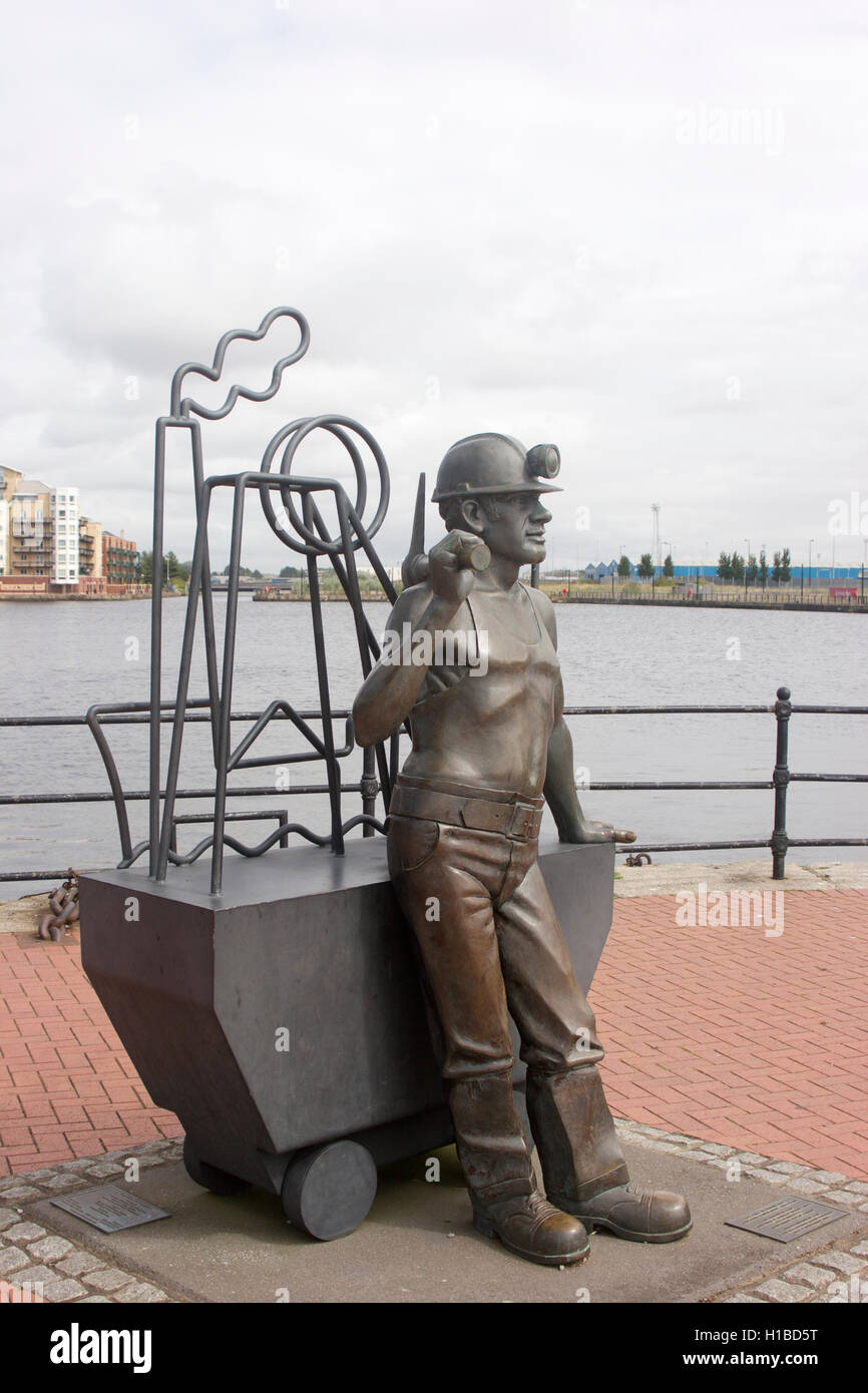 Bronze statue of a miner in the redeveloped dock area of Cardiff Stock ...