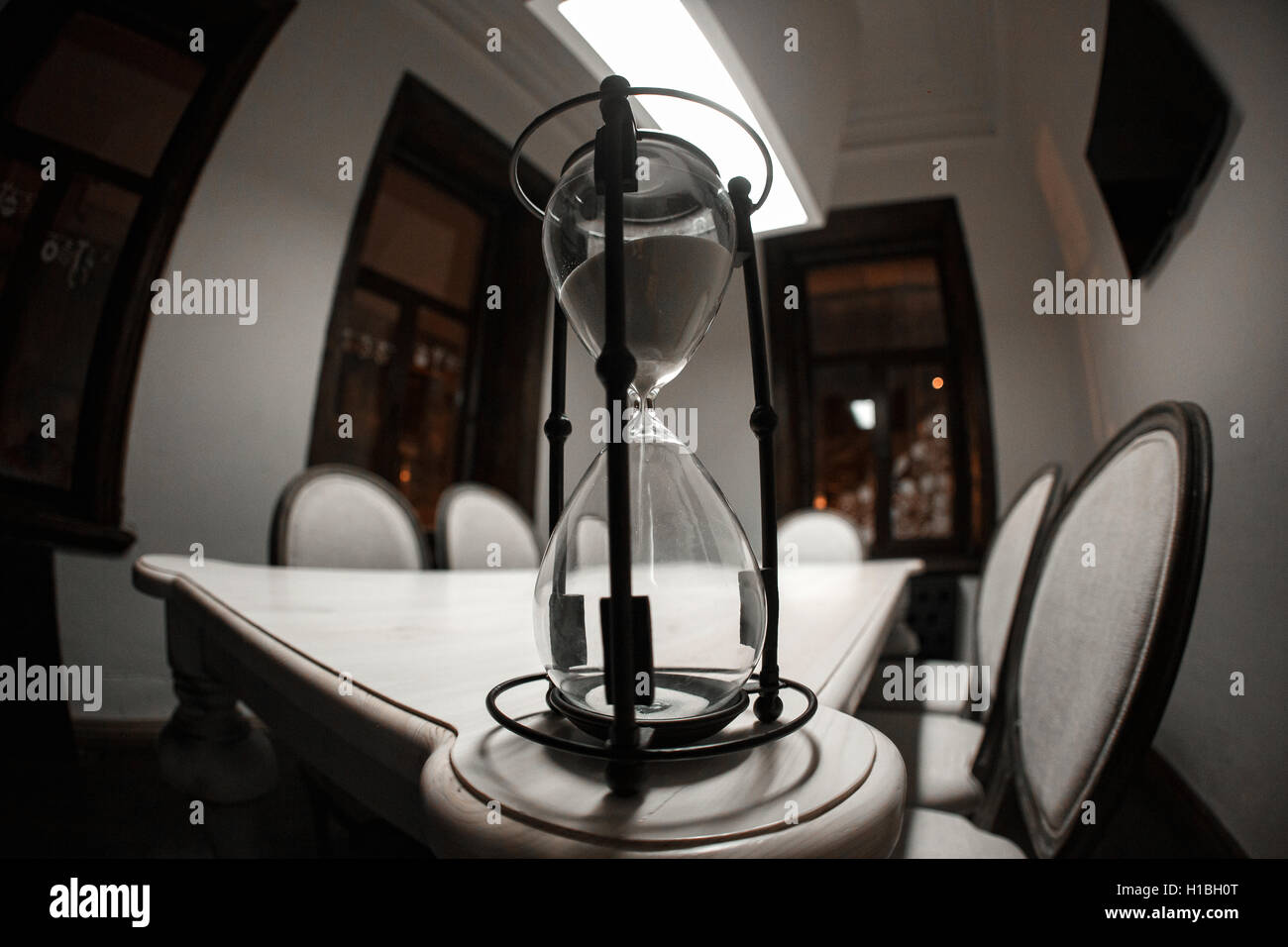 Beautiful hourglass on brown wood table with shadow Stock Photo - Alamy