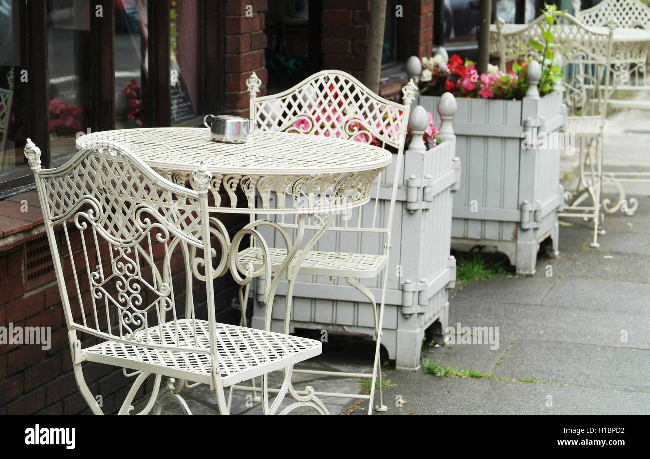 photo of a traditional English cafe with white chairs and tables Stock ...