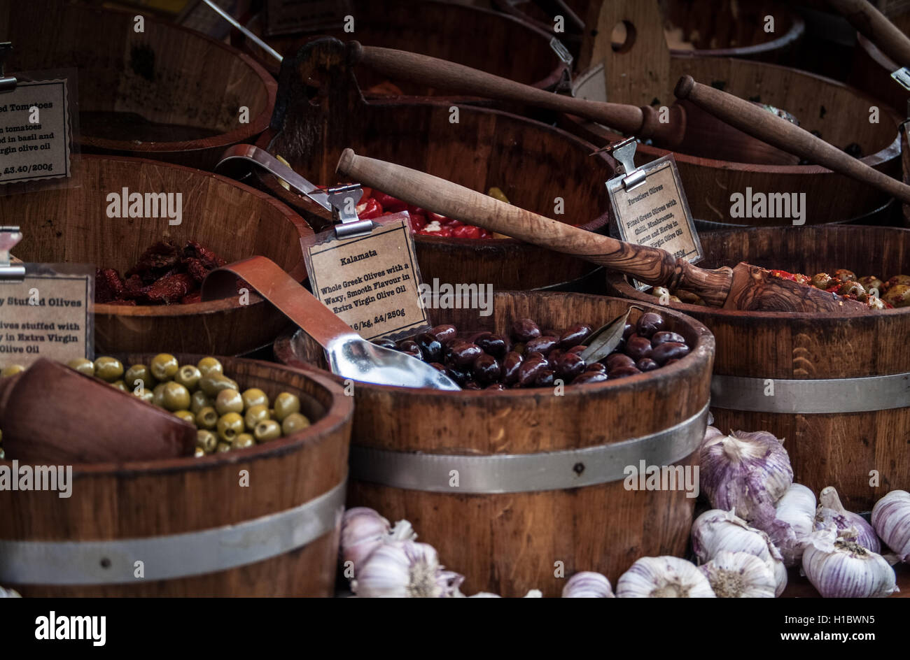 olives in a wooden barrel sold at a market Stock Photo - Alamy