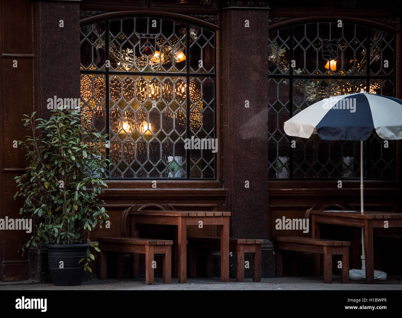 photo of a quaint English pub with wooden tables and seats outside ...