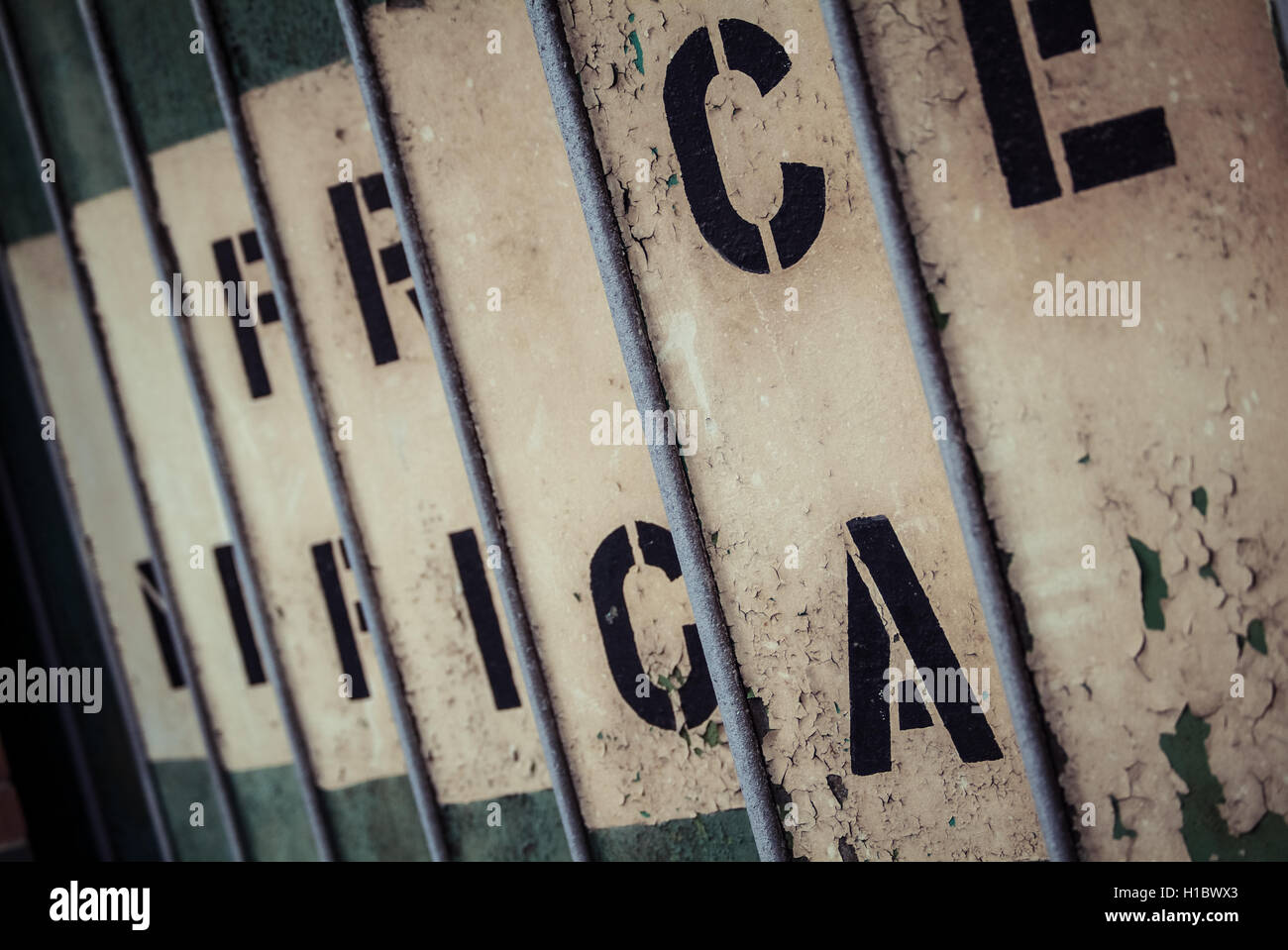 abstract photo of a metal gate with printed letters Stock Photo - Alamy