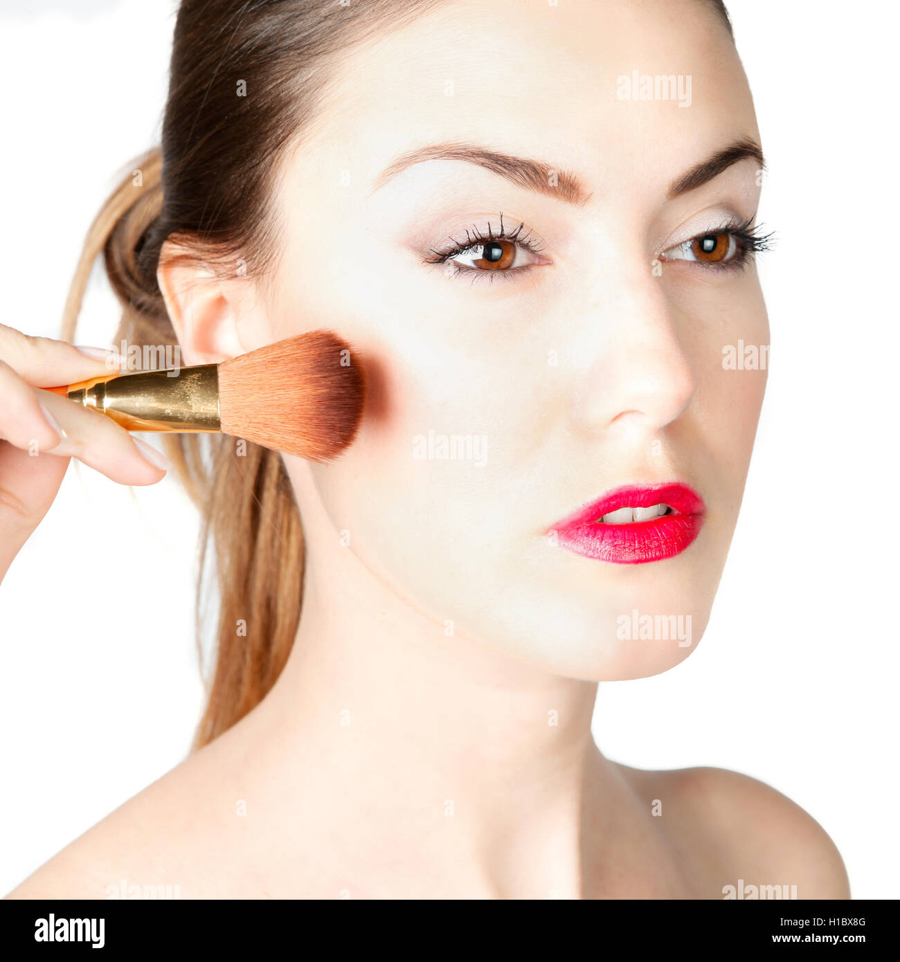 Portrait Of A Beautiful Woman As Applying Makeup Near A Mirror Photo