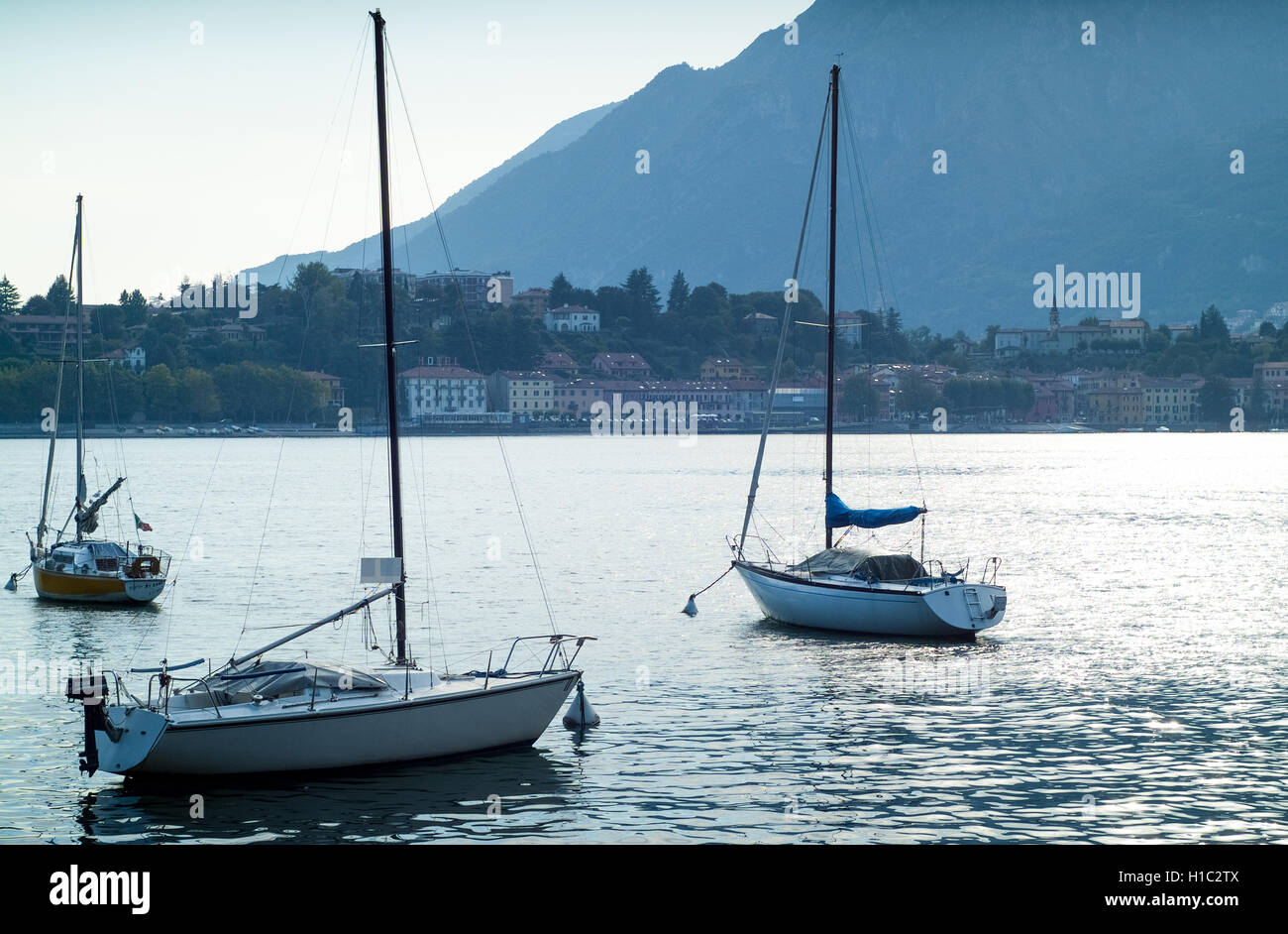 boats floating on the glittery waters of Lake Como in Italy Stock Photo ...